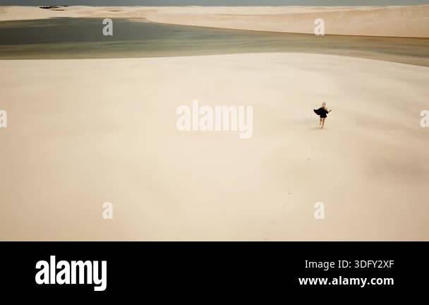 Lencois Maranhenses National Park full of dunes and lagoons. Girl ...