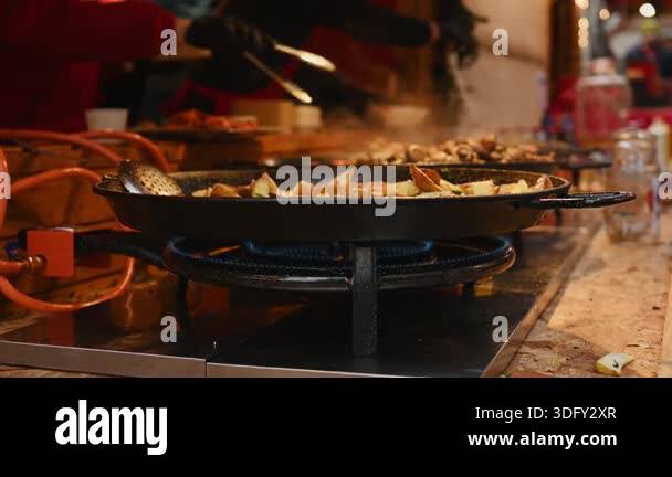 Street Food Cooked Over Fire On A Blurred Background With Chefs And ...