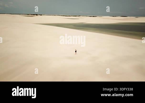 Lencois Maranhenses National Park full of dunes and lagoons. Girl ...