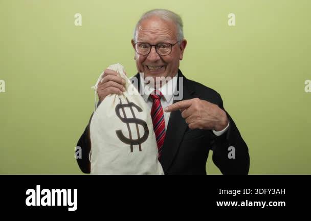 Senior man in business suit smiling with dollar bag, symbolizing wealth ...
