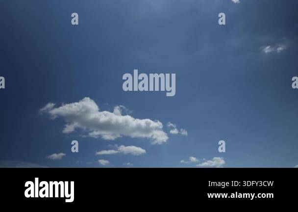 Time lapse of white clouds running on blue sky Stock Video Footage - Alamy