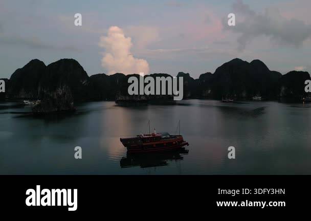 Boat floating in calm water surrounded by mountains Stock Video Footage ...