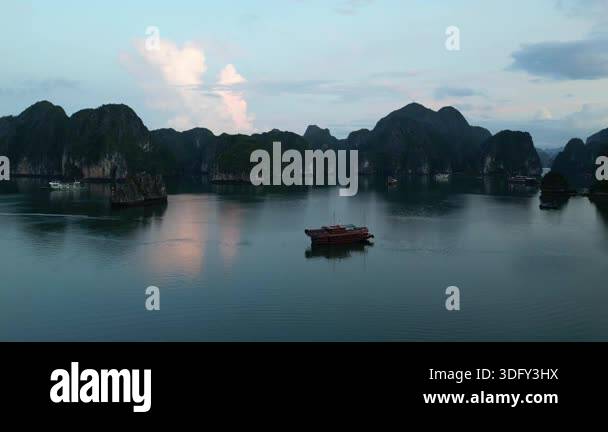 Boat floating in calm water surrounded by mountains Stock Video Footage ...