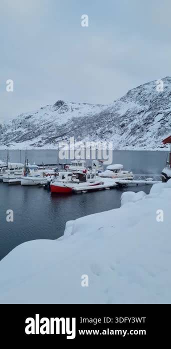 Snow blizzard and strong winds in winter at the fishing port. Polar ...