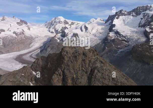 Cinematic aerial drone footage of scenic Swiss Alps. Snow-capped peaks ...