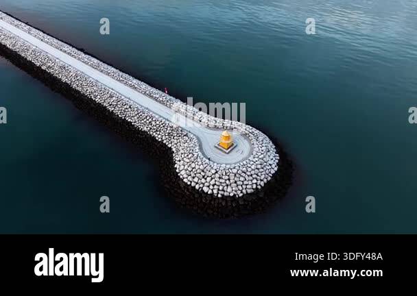 Epic smooth drone flyover above a yellow lighthouse on the Icelandic ...