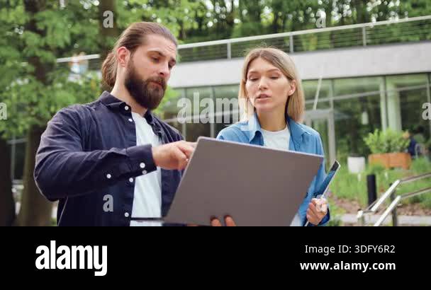 Confident Caucasian businessman in casual clothes holding a laptop ...