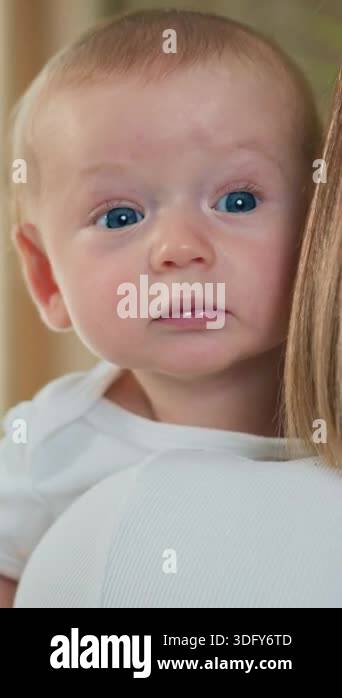 Young loving mom holding on arms her cute and smiling baby boy ...