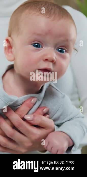 Close up of portrait little baby lies on bed smiling and posing at ...
