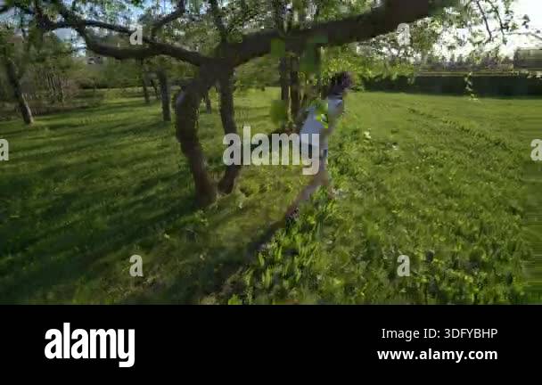 Happy young girl run and hides behind trees Stock Video Footage - Alamy