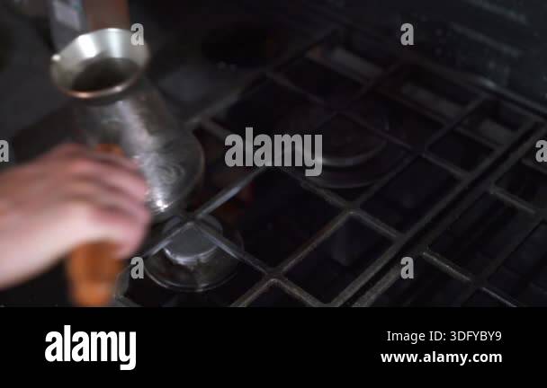 hand placing espresso maker on stove till it boils Stock Video Footage ...