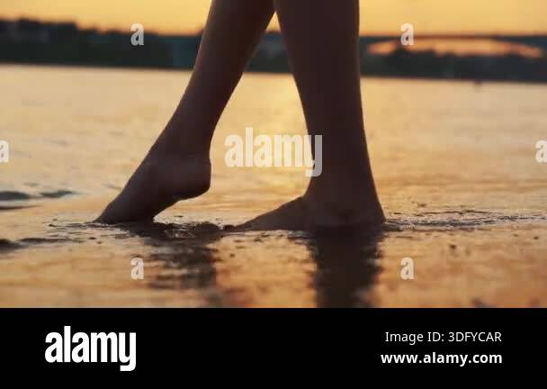 feet walking at Seashore sunset Stock Video Footage - Alamy