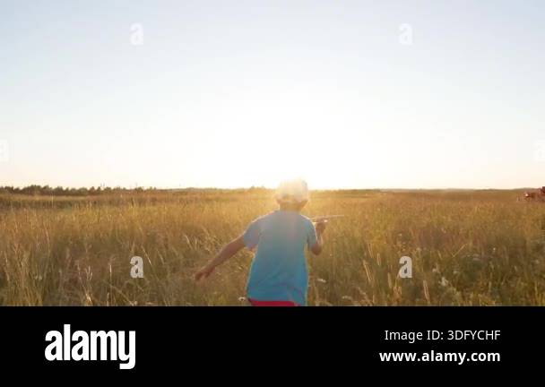 boy in wheat field running with a toy plane Stock Video Footage - Alamy