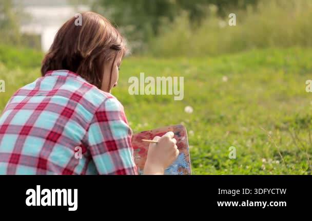 the artist sitting on grass Stock Video Footage - Alamy