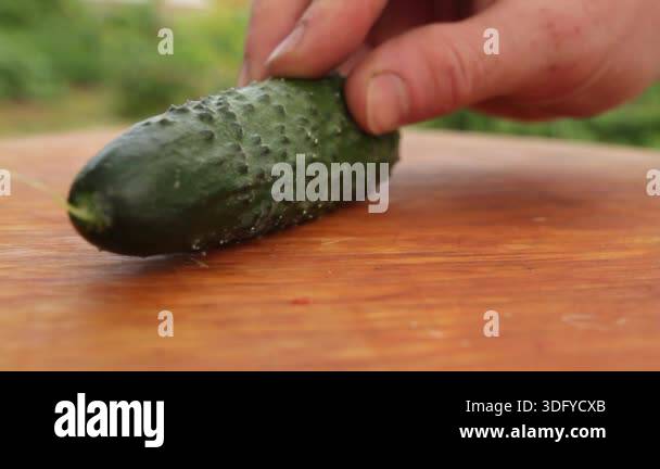cutting cucumber in a chopping wooden board Stock Video Footage - Alamy