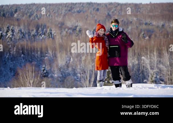 Pretty Couple In Alpine waving hands to camera Stock Video Footage - Alamy