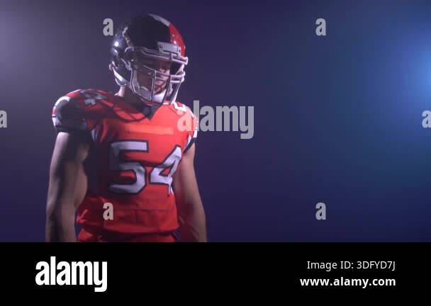 American football player in red outfit warming up Stock Video Footage ...