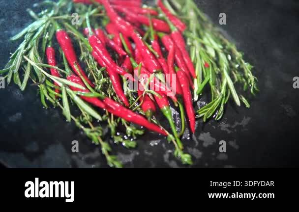 Red hot chilli under spraying water drops Stock Video Footage - Alamy