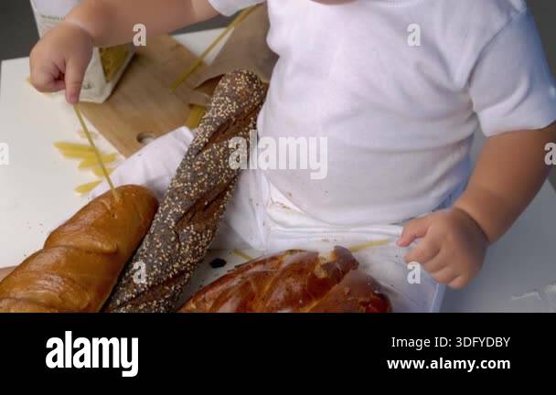 cute child playing with bread on table Stock Video Footage - Alamy
