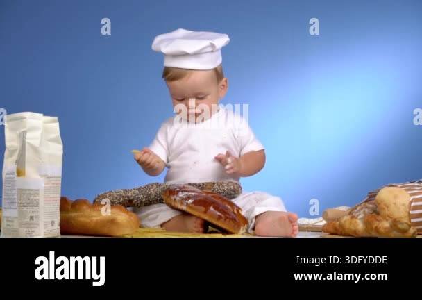 child among bread on blue wall in cook hat Stock Video Footage - Alamy