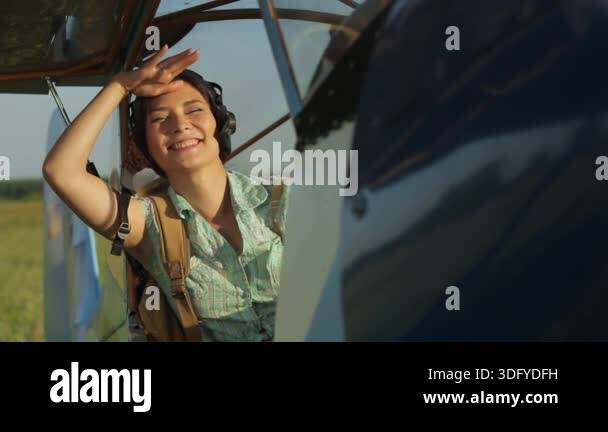 Happy woman pilot in old airplane at sunset Stock Video Footage - Alamy