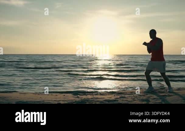 man boxing at sunset at the beach Stock Video Footage - Alamy