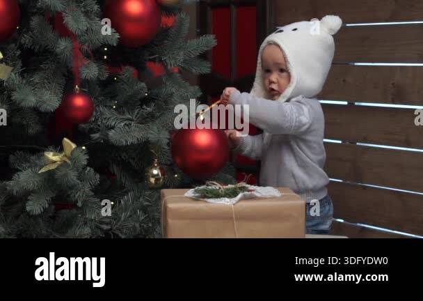 Cute Baby decorating a xmas tree Stock Video Footage - Alamy