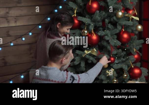 happy couple decorating xmas tree Stock Video Footage - Alamy