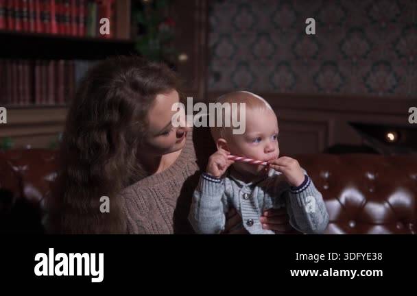 Mother with her child eating candy at xams library Stock Video Footage ...