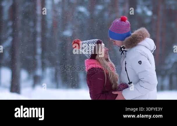 Happy winter travel couple in love under snowfall Stock Video Footage ...