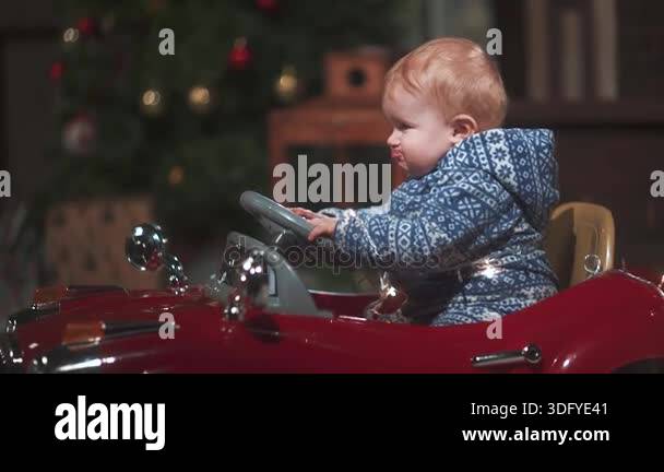 Baby Boy riding a tiny car at xmas Stock Video Footage - Alamy