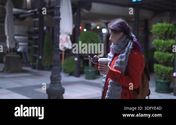 Girl drinking coffee and using phone in the street Stock Video Footage ...