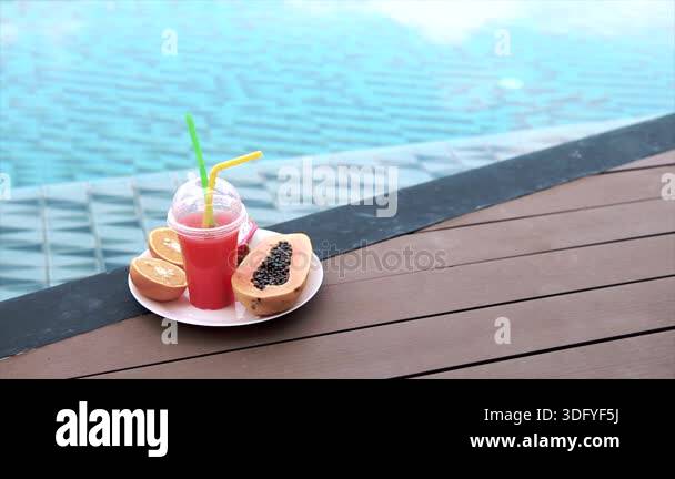 Cocktail and fruit near the swimming pool Stock Video Footage - Alamy