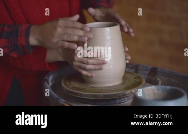 Hands making clay jug on potters wheel Stock Video Footage - Alamy