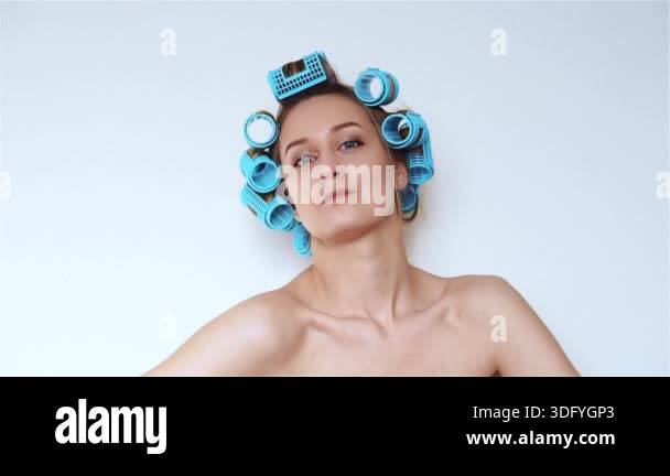 Beautiful girl in hair curlers isolated Stock Video Footage - Alamy