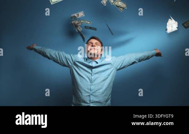 Excited man standing with arm folded in money rain Stock Video Footage ...