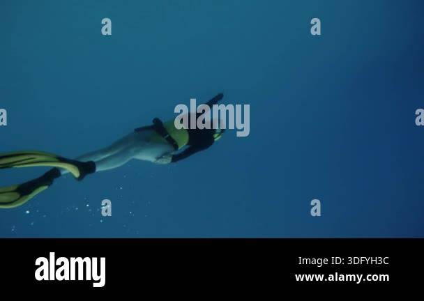 A young woman free diving deep underwater Stock Video Footage - Alamy