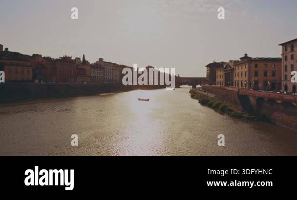 Boat floating on a river in Florence Stock Video Footage - Alamy