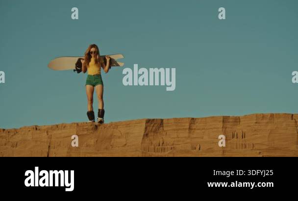 girl sandboarder on a cliff, extreme sport Stock Video Footage - Alamy