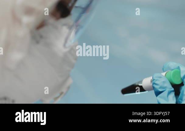 Closeup of microbiologist or medical worker wearing blue surgical ...