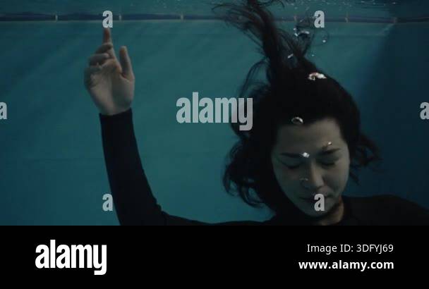 A girl sink in the pool Stock Video Footage - Alamy