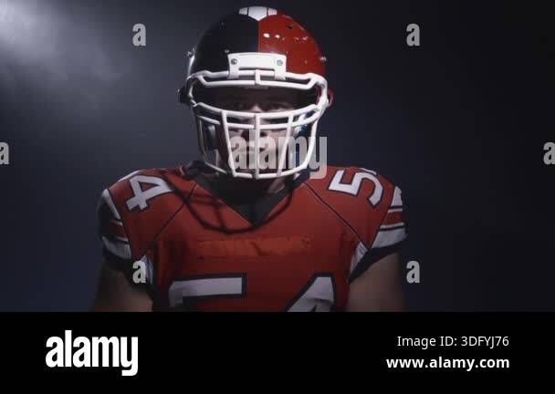Portrait of determined professional American football player in helmet ...