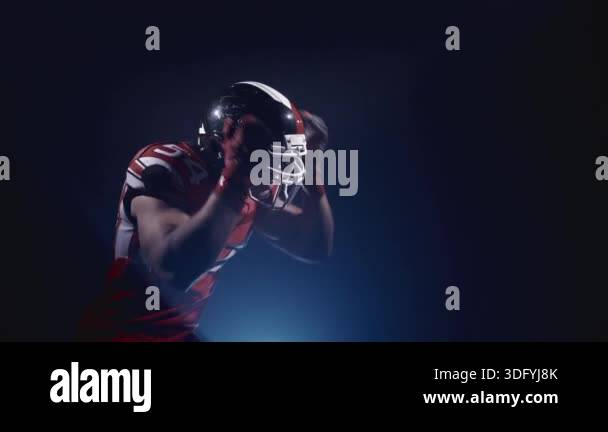 Portrait of determined professional American football player in helmet ...