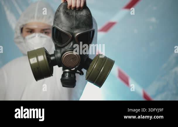 Female doctor virologist in a protection suit and respirator holds a ...
