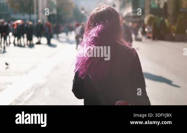 Music lifestyle concept. Daring rebel woman with purple hair walking ...