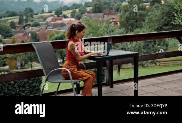 Social distance working. Asian woman sitting alone in her garden and ...
