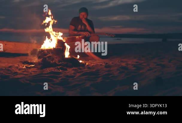 Solo activity and social distancing. Lonely man sitting by bonfire on ...