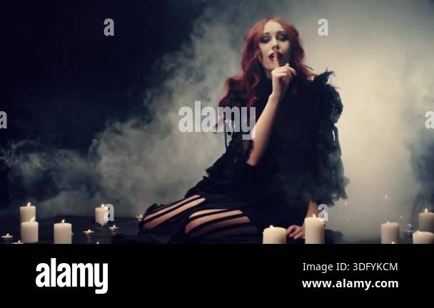 Woman dressing in dark casts, spelling, conducting ritual and summon ...