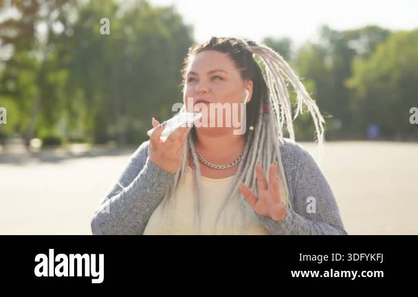 Female holdig mic to fix her ideas. Happy fat woman recording audio ...