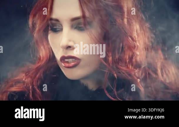 Portrait witch witch with red hair and devil horns. Woman smiling ...